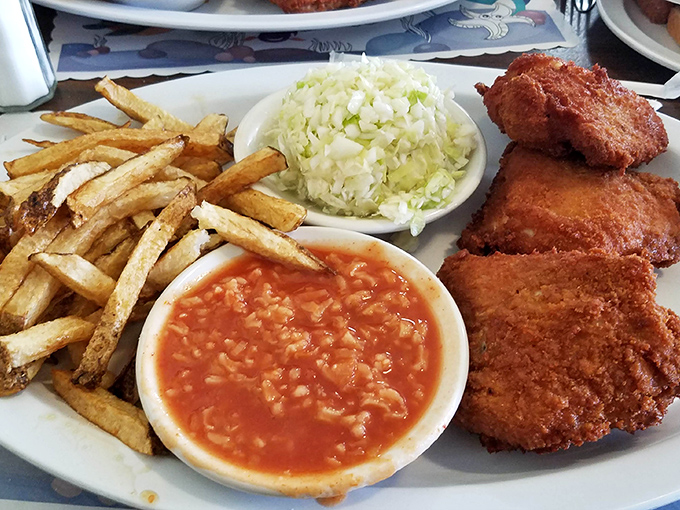 Classic chicken dinner with all the fixings – coleslaw, beans, and memories of Sunday dinners at grandma's house.