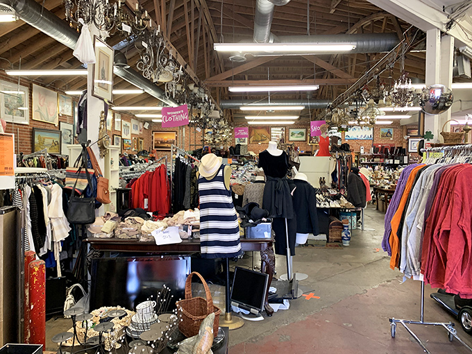 The clothing section – where vintage dresses hang like patient time travelers waiting for their next adventure at your dinner party.