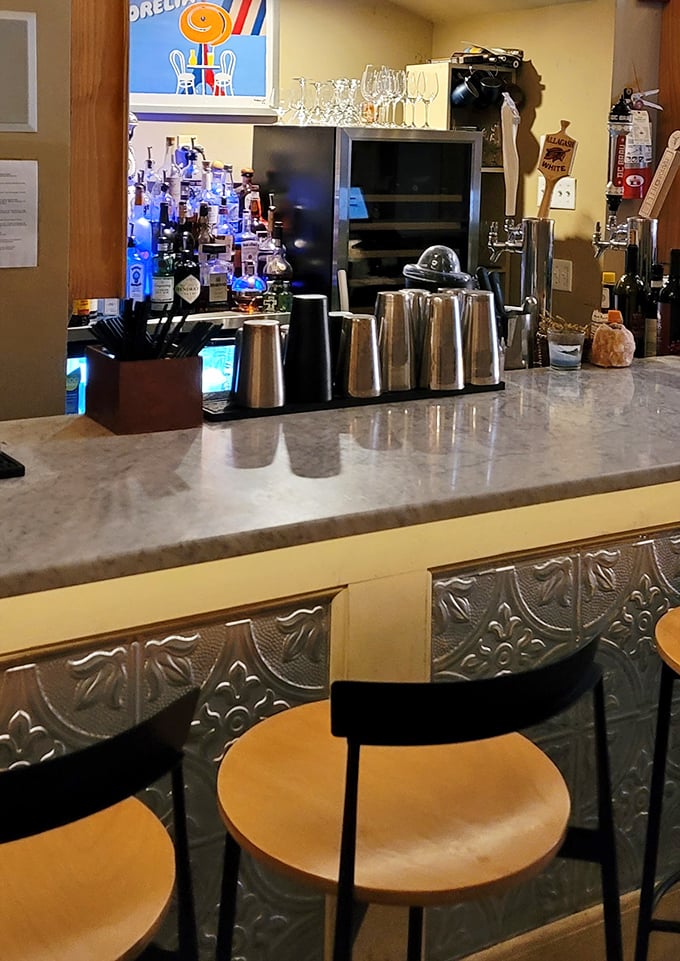The bar area combines marble countertops with vintage-inspired tin details—like your stylish grandmother's kitchen got a modern upgrade.