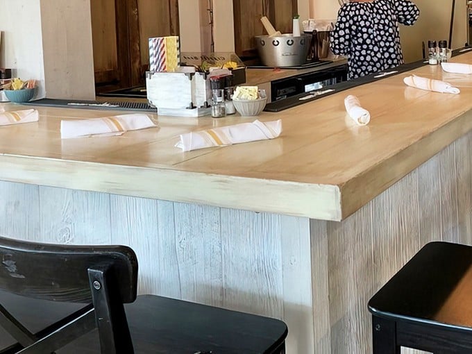 The counter seating offers a front-row view to breakfast artistry in action. Sometimes the best theater in town happens in the kitchen.