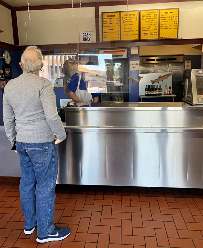 The timeless ritual of ordering at the counter – where regulars and first-timers alike stand in anticipation of crispy treasures.