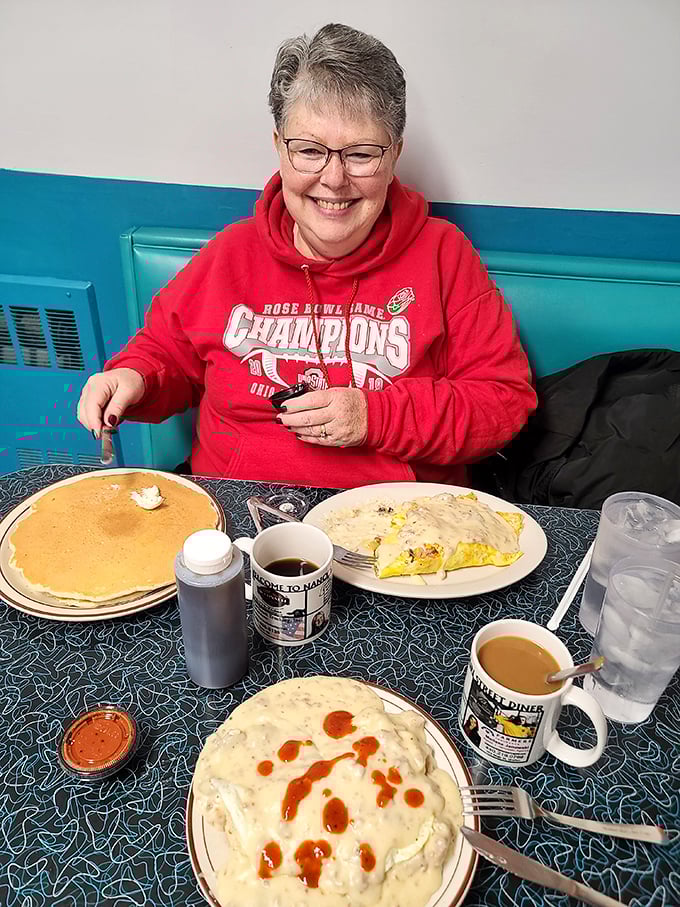 The smile says it all – massive pancakes, a hearty omelet, and biscuits with gravy creating the kind of breakfast euphoria money can't usually buy.