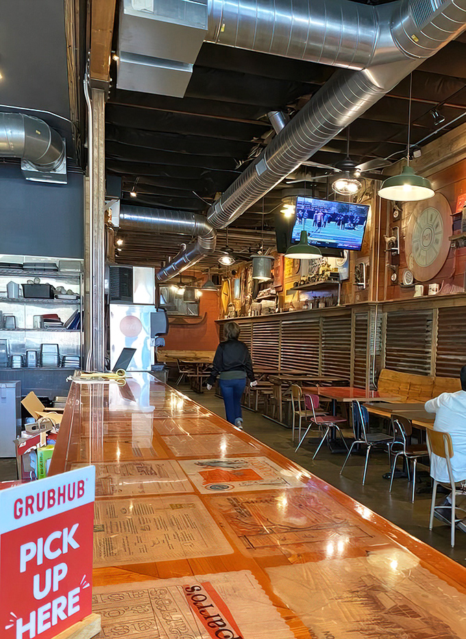 The long wooden counter isn't just functional—it's where chicken dreams come true. Note the Grubhub sign: civilization's gift to the hungry homebody.
