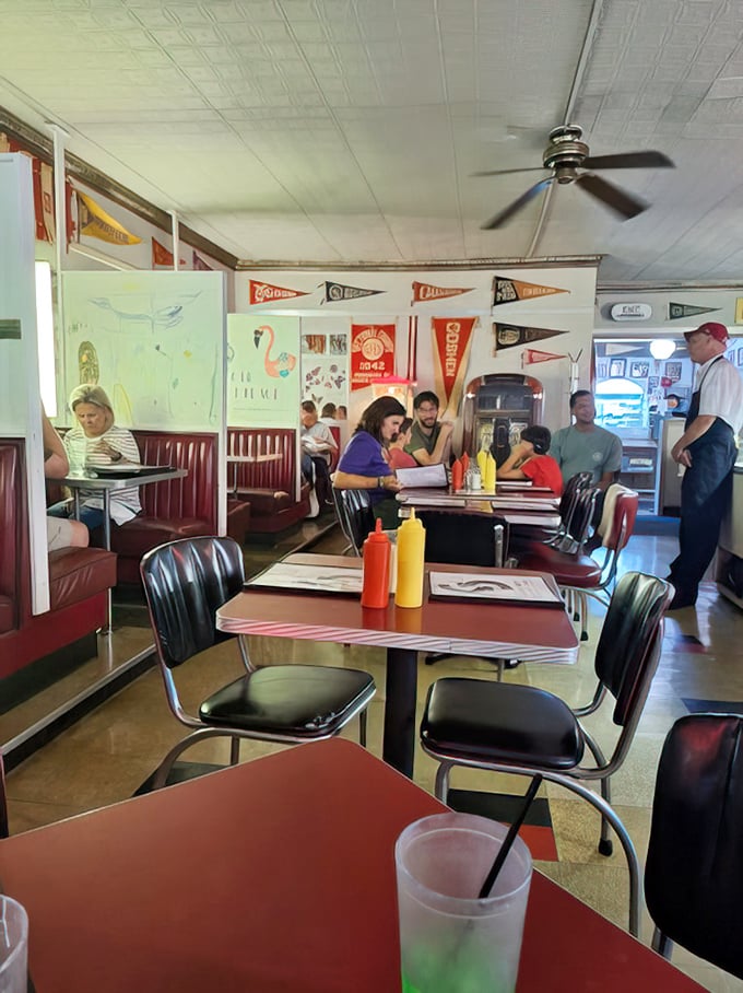 Red vinyl booths, vintage pennants, and classic condiment bottles—this isn't manufactured nostalgia, it's the real deal that's earned every scuff and scratch.