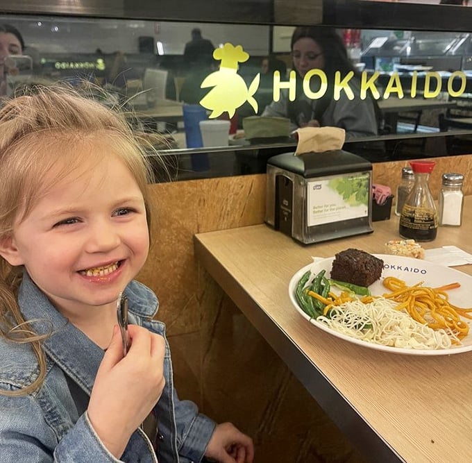 Even the youngest diners find joy at Hokkaido, where culinary adventures begin early. That smile says it all – future foodie in training.