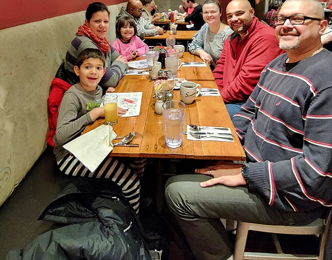 Families gathering around wooden tables, creating memories one pancake stack at a time. This is what breakfast was meant to be.
