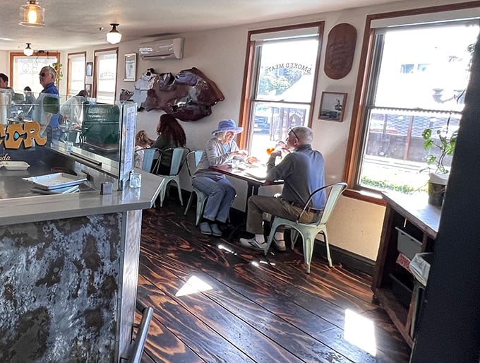 The dining room buzzes with the quiet contentment of people experiencing meat nirvana. Notice nobody's talking—they're too busy savoring.