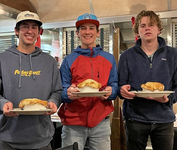 Happy diners showing off their breakfast burritos – the universal expression of "worth getting out of bed for" on full display.