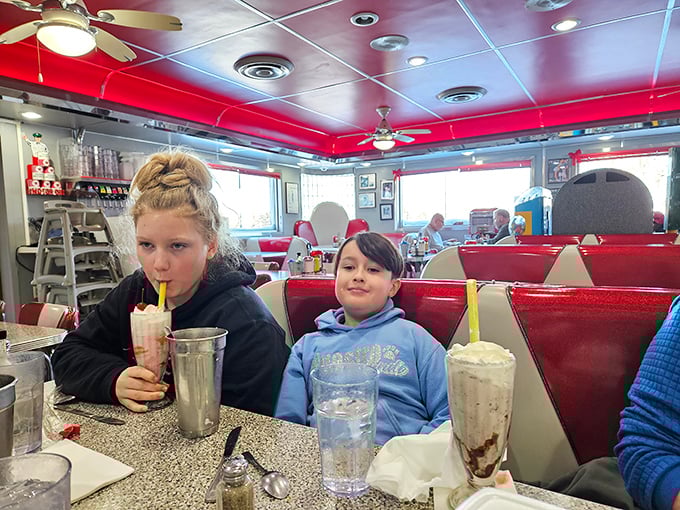 Milkshakes so thick they require serious straw skills – these young diners are up for the challenge in Gus's classic red and white booths.