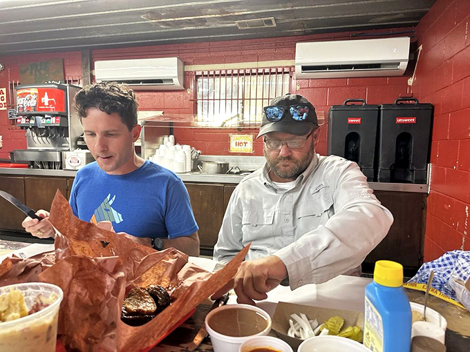 The sacred ritual of Texas barbecue—selecting your meat directly from the pit, where the pit master becomes both guide and gatekeeper.