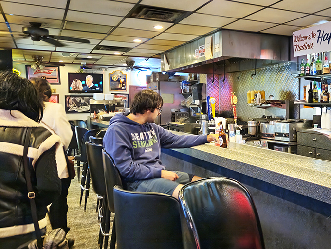 The counter at Nadine's – where strangers become regulars and regulars become family. Notice nobody's looking at their phone? That's called conversation.