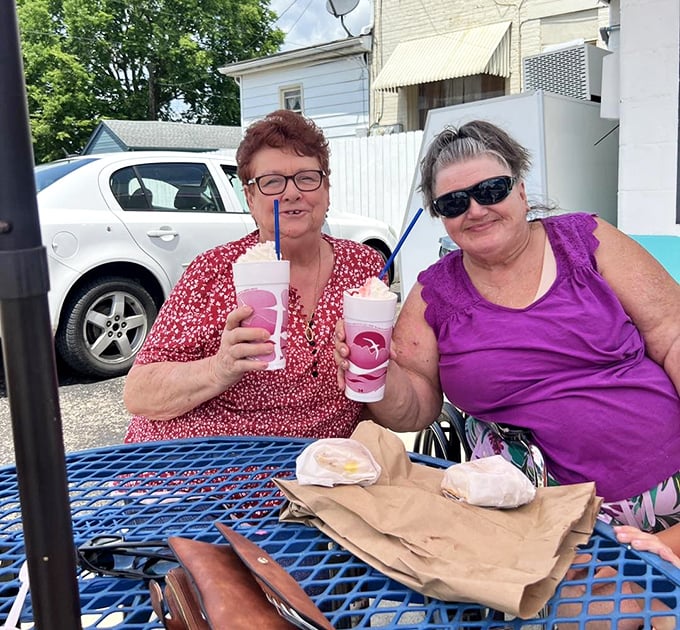 The blue picnic tables outside Sweden Creme have witnessed countless first dates, family celebrations, and the simple joy of cold treats on hot days.