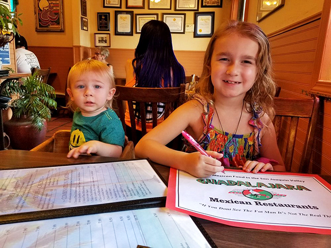 Kids coloring on menus—the universal sign you've found a place where families have been making memories over meals for generations.