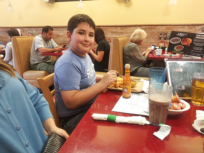 The dining room shows the true measure of any great eatery—happy patrons of all ages enjoying food worth putting the phone down for.