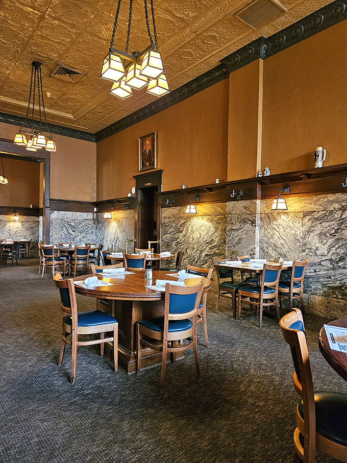 Marble walls meet ornate ceilings in this dining room where every table feels like the best seat in the house.