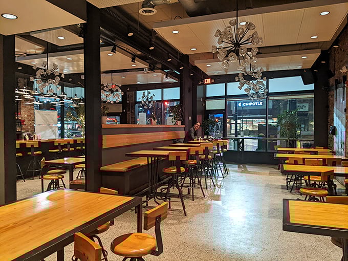 Modern industrial meets warm hospitality in a dining space that invites you to linger. Those starburst chandeliers add just the right touch of unexpected elegance.
