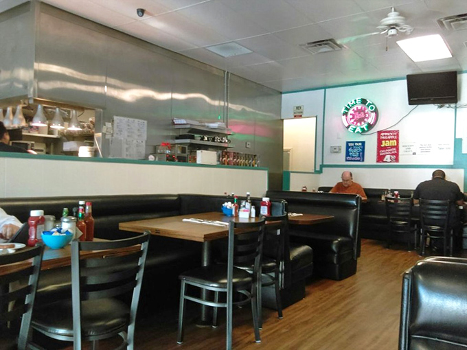 Classic diner aesthetics with those teal accents – where conversations flow as freely as the coffee refills.