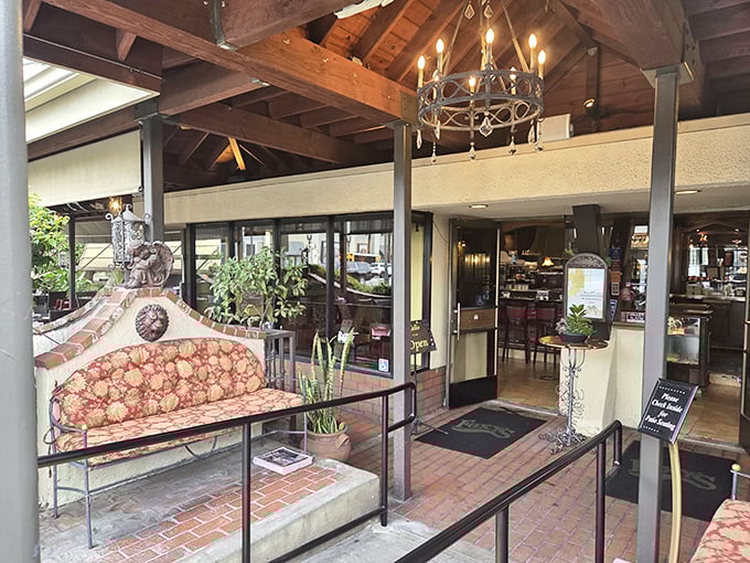 The entrance patio feels like the front porch of that cool relative who always had the best snacks. Red cushions invite you to linger.