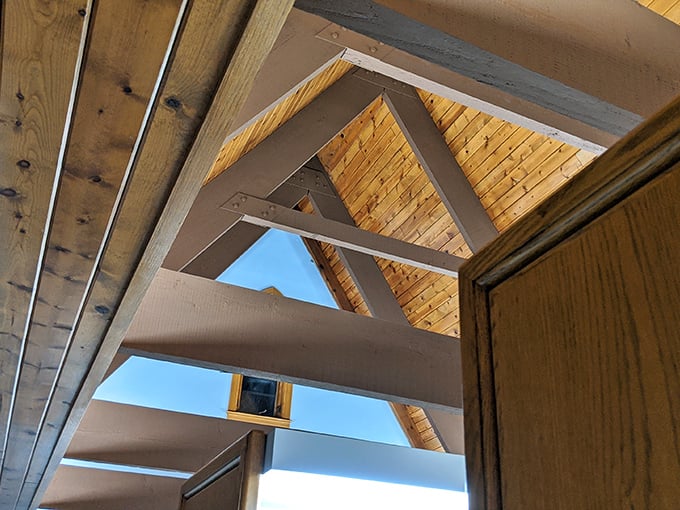 Look up to discover architectural poetry. These wooden beams and trusses reveal the craftsmanship that makes this library both sturdy and stunning.