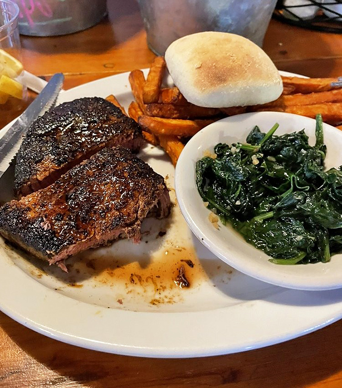 A perfectly seared filet, sweet potato fries, and garlicky spinach. This plate doesn't need filters or hashtags—just your undivided appreciation.