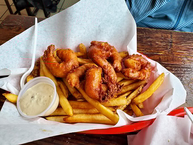Golden-battered shrimp nestled among crispy fries—comfort food that somehow tastes like both childhood memories and sophisticated adult pleasures.