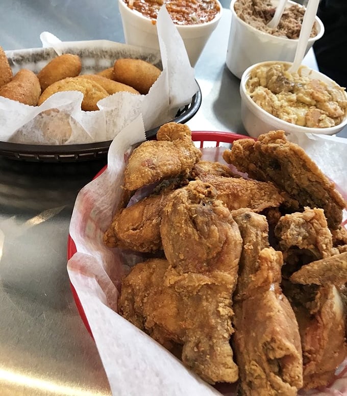 Fried chicken that rivals the barbecue for attention. Golden-brown perfection surrounded by hush puppies and sides that make choosing just two a genuine Sophie's choice.