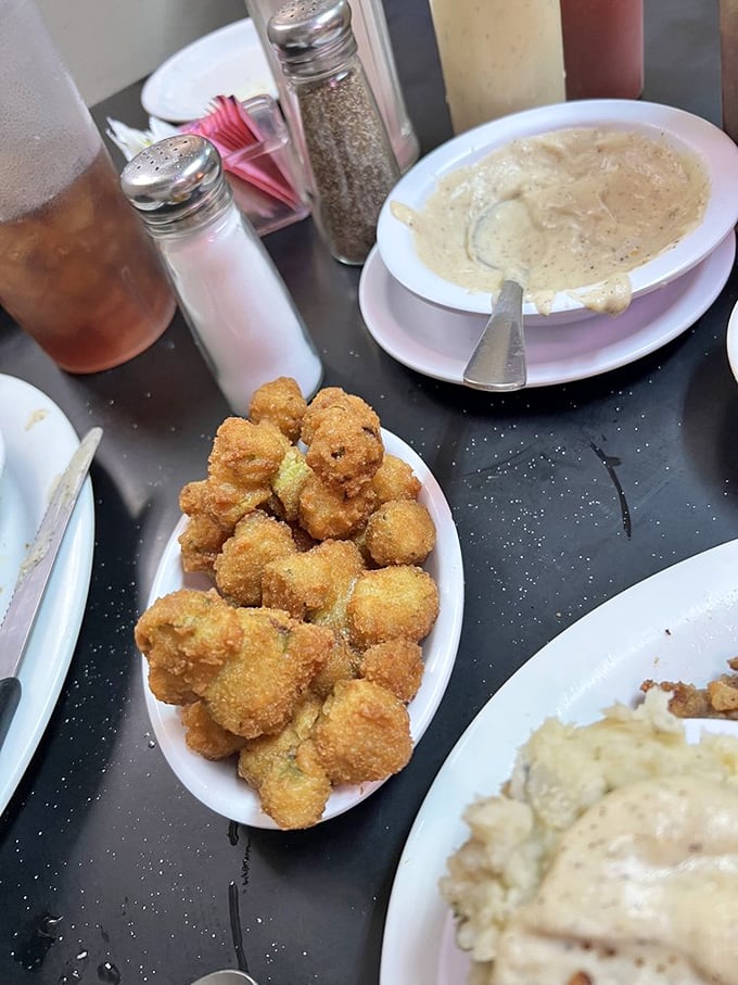 Those golden nuggets of fried okra aren't just a side dish – they're little Southern treasures that disappear from the plate mysteriously fast.