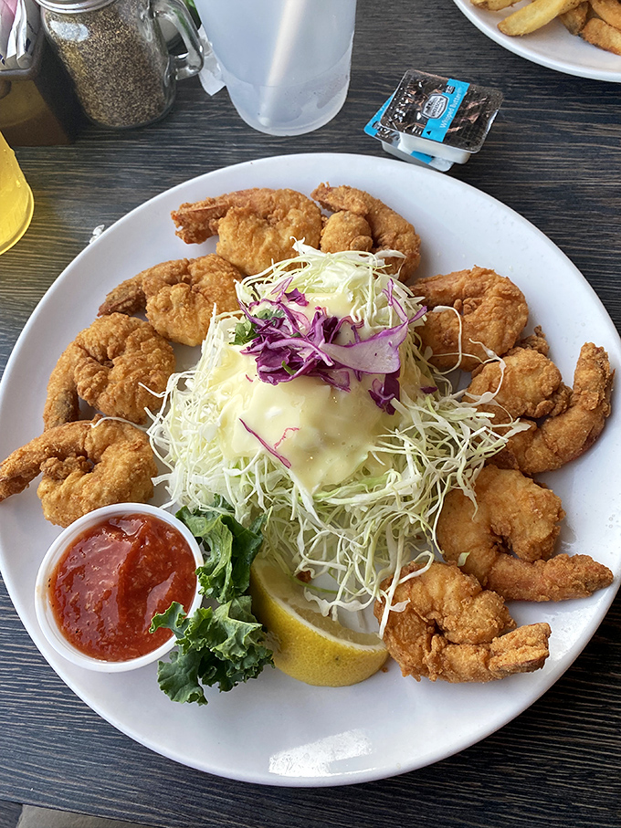 A golden halo of perfectly fried shrimp surrounding a fresh salad – like the seafood equivalent of angels singing on your plate.