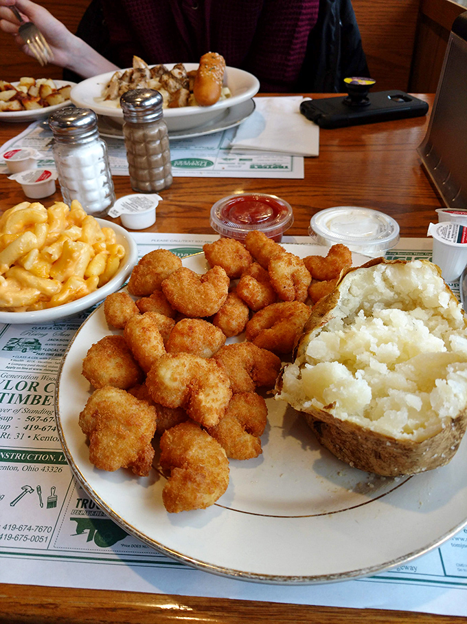 Golden-fried shrimp huddle together like delicious little life rafts on a sea of mashed potatoes. That baked potato looks like it's been working out.