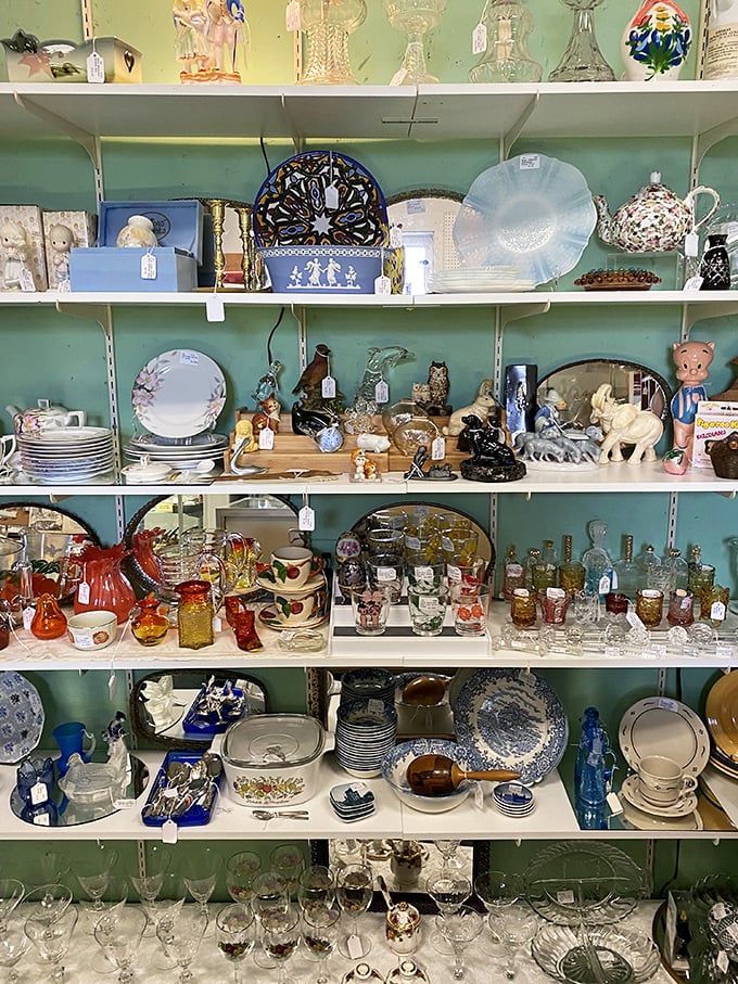 Shelves of glassware and ceramics arranged by color tell the story of American dining tables through the decades – from Depression glass to mid-century modern.