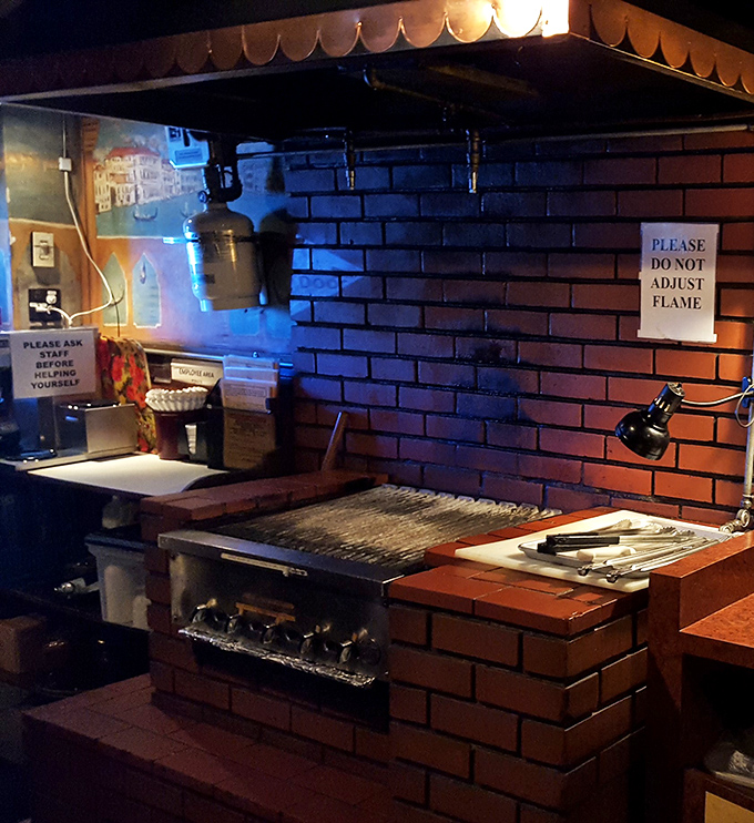 The legendary grill station – hallowed ground where novices become masters and every steak bears the unique signature of its temporary chef.