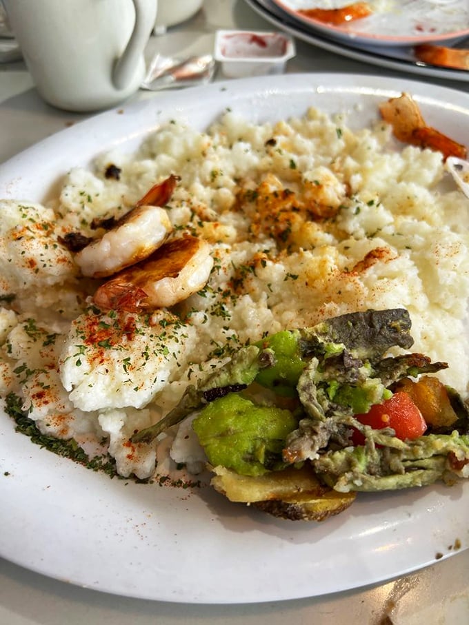 Shrimp and grits that would make a Southerner nod in approval—creamy, comforting, and proof that breakfast knows no regional boundaries.