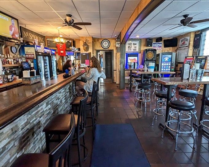 The bar area—where strangers become friends and friends become family. That worn wooden counter has heard more small-town stories than the local newspaper.