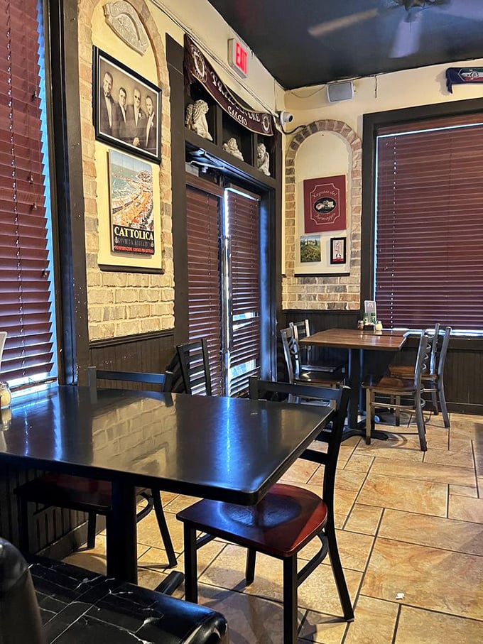 The dining room whispers stories of Italian heritage through brick walls and carefully chosen photographs—a sanctuary for serious pizza devotees.