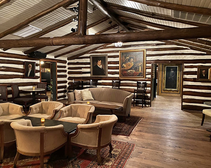 Not your average log cabin living room—unless your living room features museum-worthy portraits, exposed beams, and the promise of exceptional food.