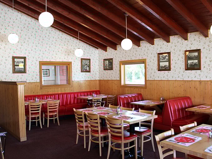 Red booths, wood paneling, and cherry-patterned wallpaper – dining room design by way of 1965, and we wouldn't have it any other way.