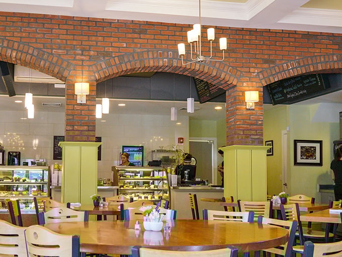 Exposed brick arches frame the bustling café area, where the serious business of enjoying good food happens beneath warm lighting.
