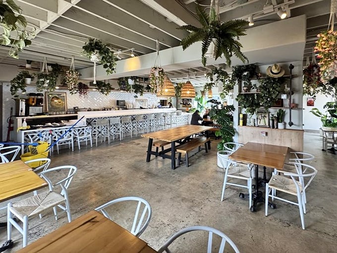 The airy interior feels like dining in a greenhouse designed by someone with impeccable taste. Those pendant lights? I want them in my house immediately.