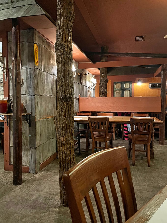 Tree trunks incorporated into the dining room – because nothing says "authentic rustic" quite like actual nature brought indoors.