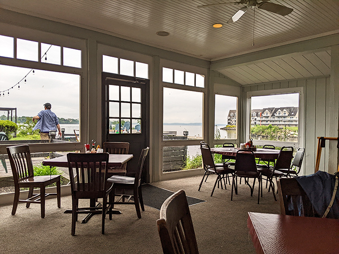 The enclosed porch dining area offers front-row seats to nature's daily performance. Water views and good food—a combination that never goes out of style.