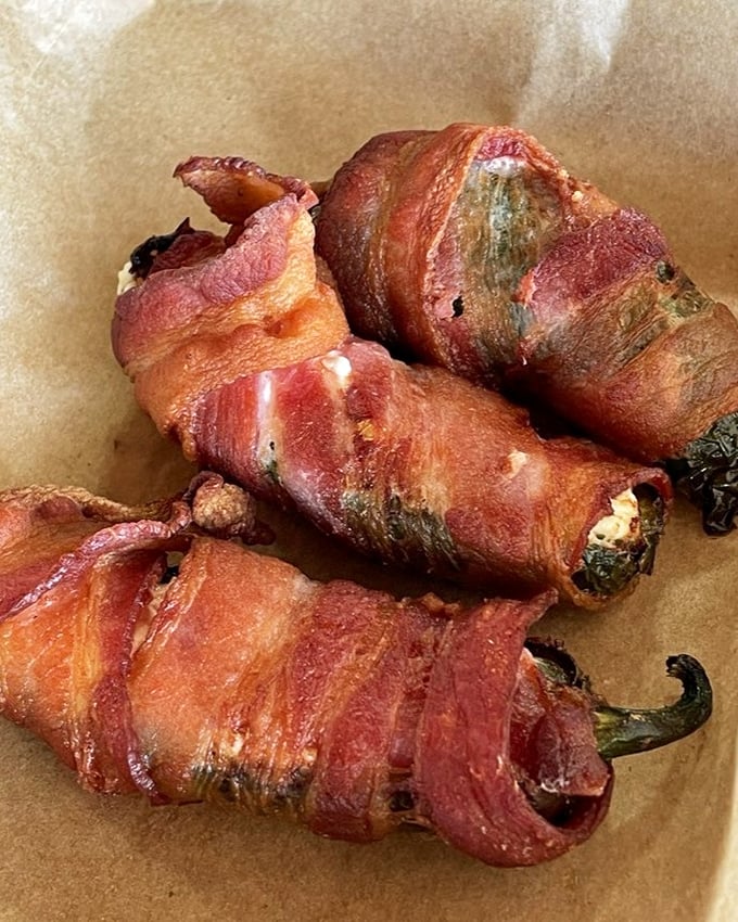Bacon-wrapped jalapeño poppers—where heat meets sweet meets savory. These little flavor bombs should come with a warning label for addictiveness.