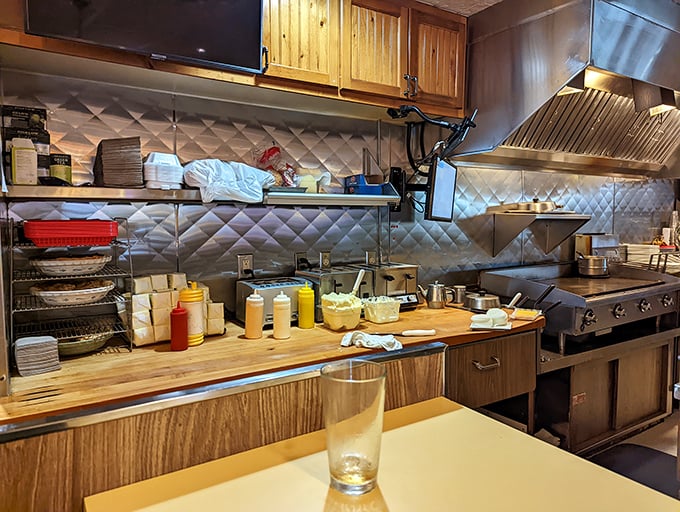 The kitchen at Solly's—where butter dreams are born. That quilted stainless steel backdrop is basically the Hollywood backdrop for comfort food.