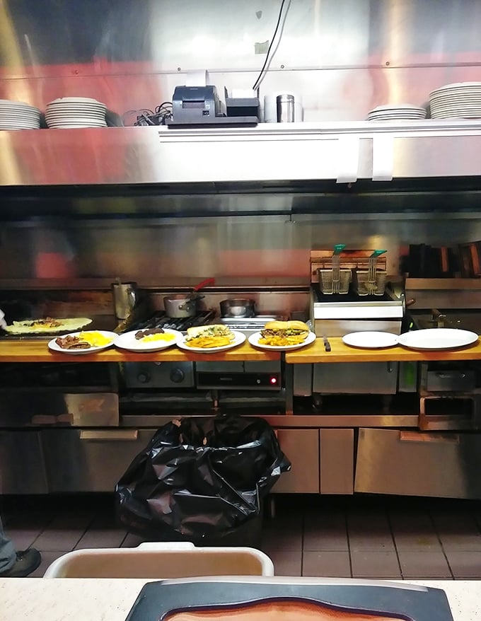 Where the magic happens—a kitchen view that reveals the choreographed dance of short-order cooking. Those plates lined up like soldiers ready for delicious duty.