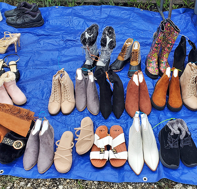 A rainbow of footwear possibilities spread across blue tarp – from practical boots to stylish ankle booties, all waiting for their Cinderella moment.