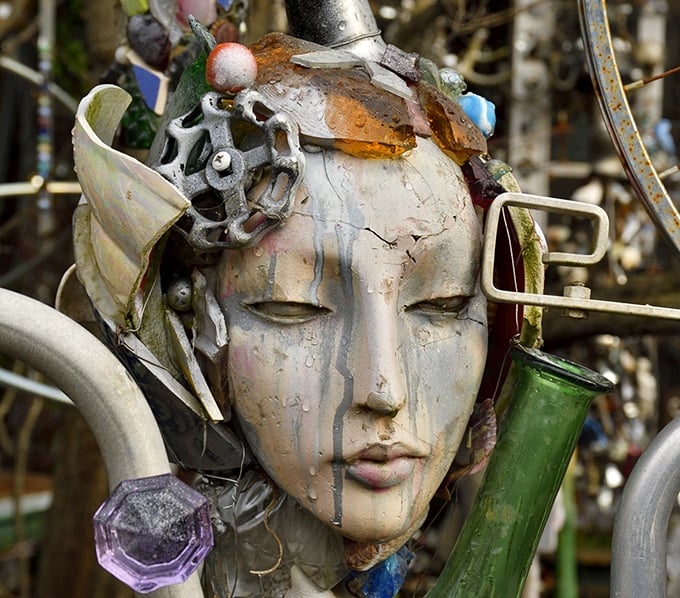 Weather-worn and wonderful, this face emerges from the metallic tapestry like a modern Medusa—hypnotizing rather than petrifying passersby.