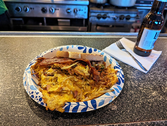A breakfast scramble that doesn't know the meaning of restraint – eggs, cheese, and meat in perfect harmony on that distinctive blue-patterned plate.