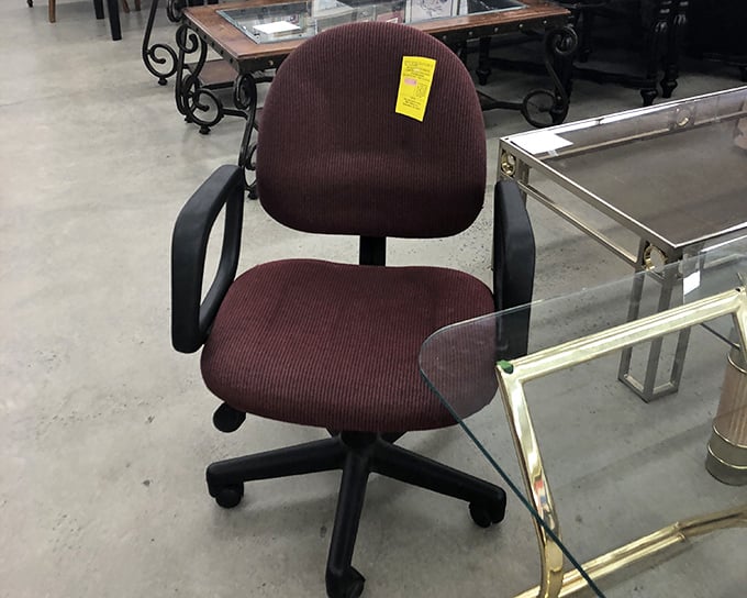 This office chair isn't just furniture – it's someone's future command center. With its burgundy upholstery still intact, it awaits its next career move.
