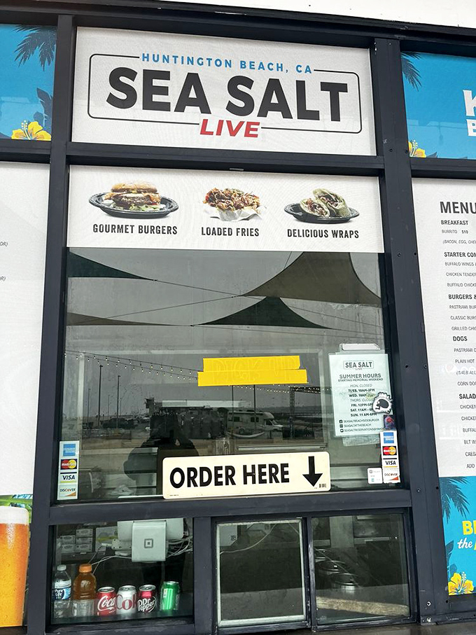 The gateway to gastronomic happiness. Sea Salt's ordering window promises "Gourmet Burgers," "Loaded Fries," and "Delicious Wraps" – three pillars of beachside contentment.