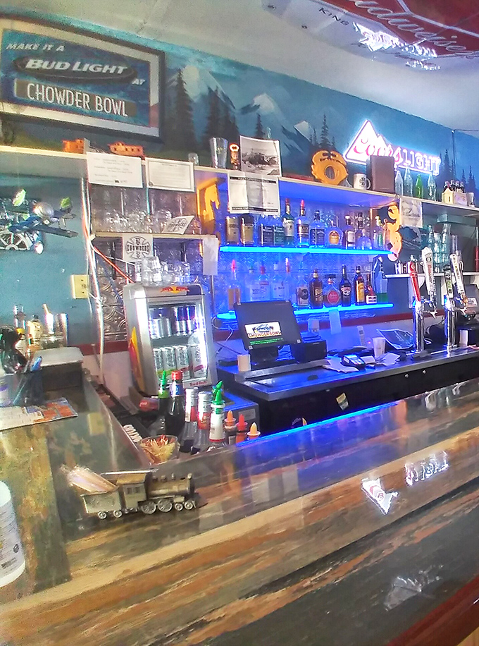 The bar area glows with neon signs and coastal charm—where locals and tourists alike gather to toast the day's adventures.