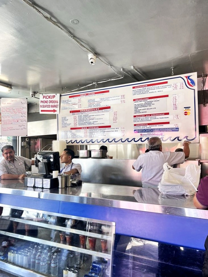 The ordering counter—command central for seafood operations. Where decisions are made, appetites are anticipated, and seafood journeys begin with a simple point and nod.